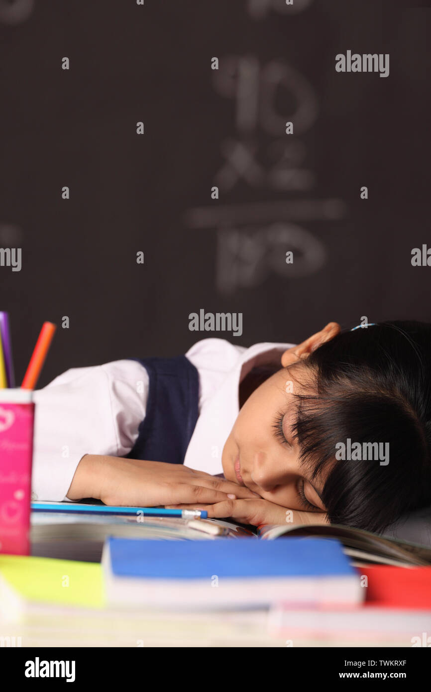 Schoolgirl napping in a classroom Stock Photo - Alamy