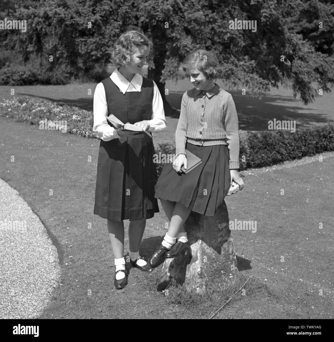 Two girls posing in school uniform on a croquet lawn c1948. Photo by ...
