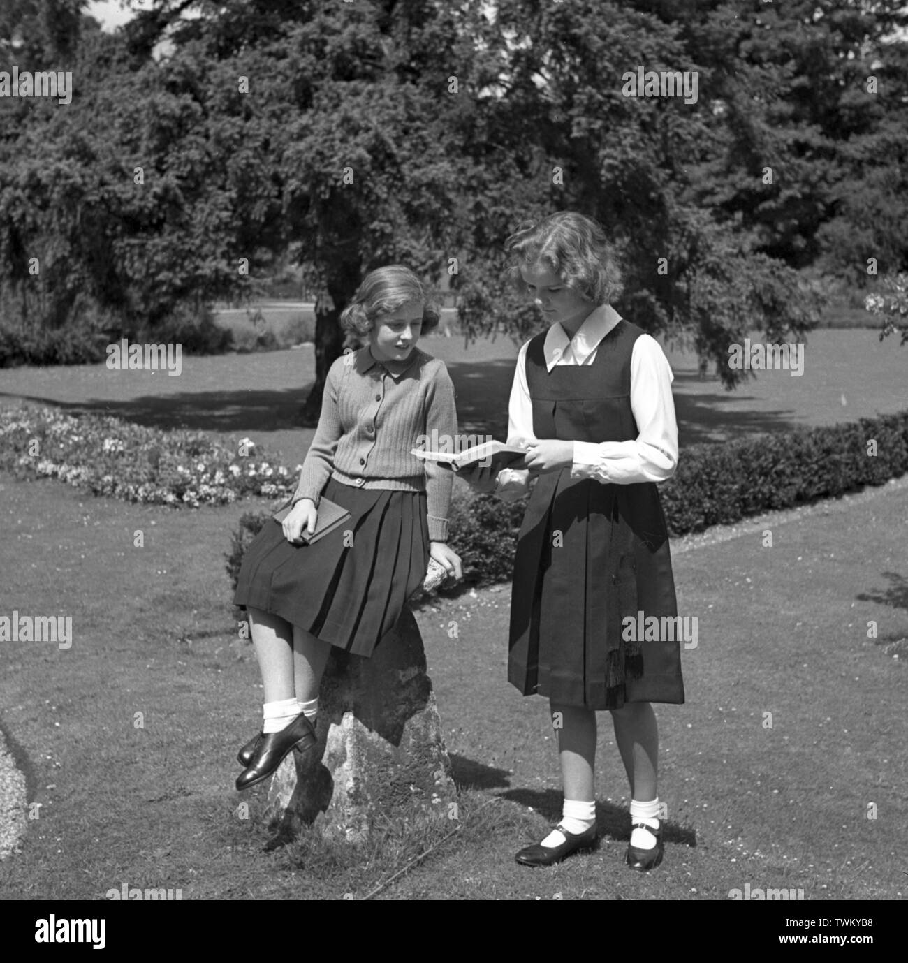 Two girls posing in school uniform on a croquet lawn c1948. Photo by ...