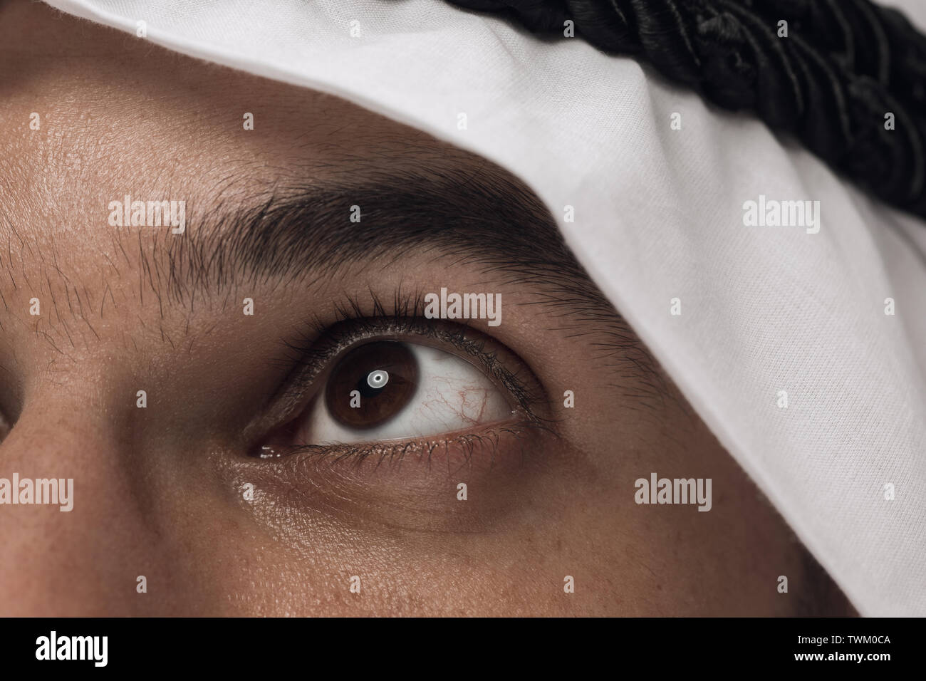 Close up portrait of arabian saudi businessman on dark blue studio ...