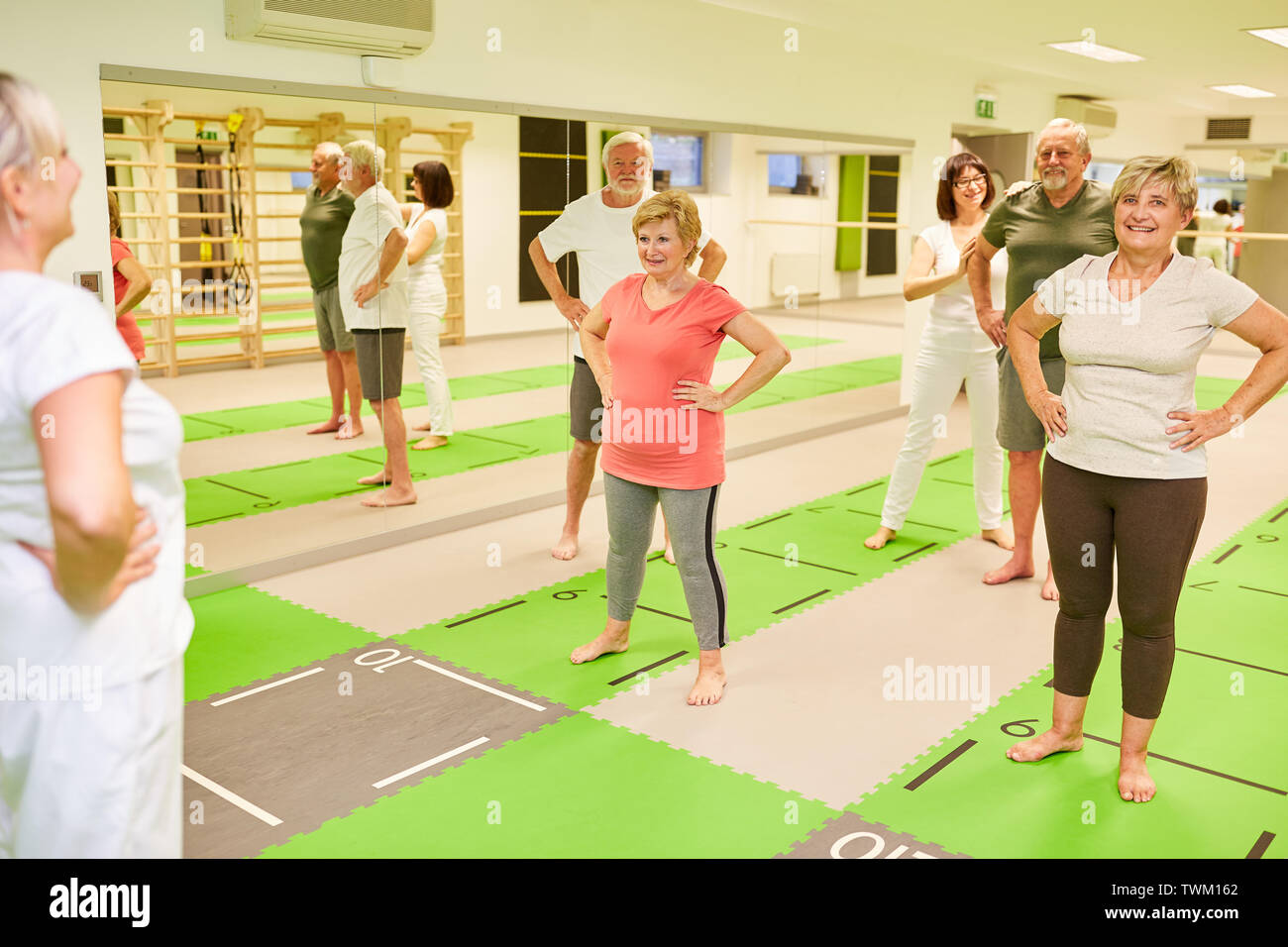 Senior group in a back school with trainer guide in physiotherapy Stock ...