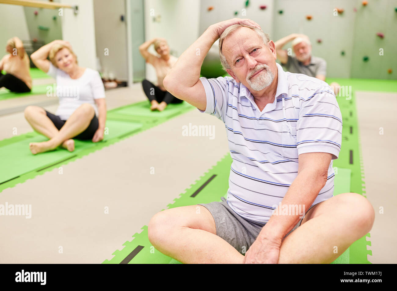Group of seniors doing sports at back gymnastics class in Pilates ...