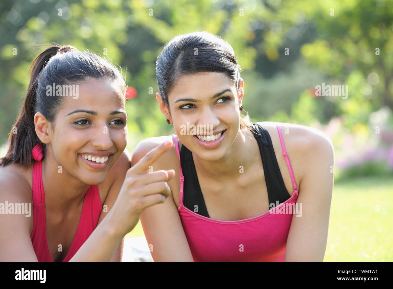 Woman showing something to her friends Stock Photo - Alamy