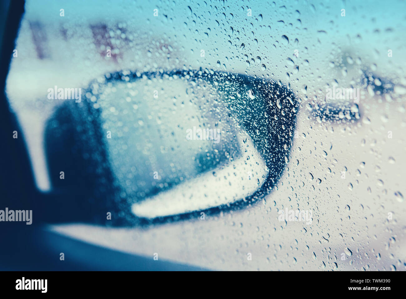 Blurry wet abstract glass background. Rear back view car mirror with ...