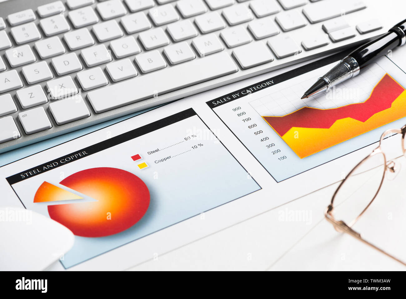 Business workplace with keyboard mouse and papers with graphs and ...