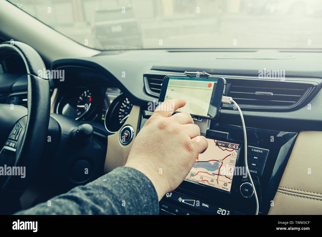 Closeup of man hands choosing route on map. Person smartphone satellite ...