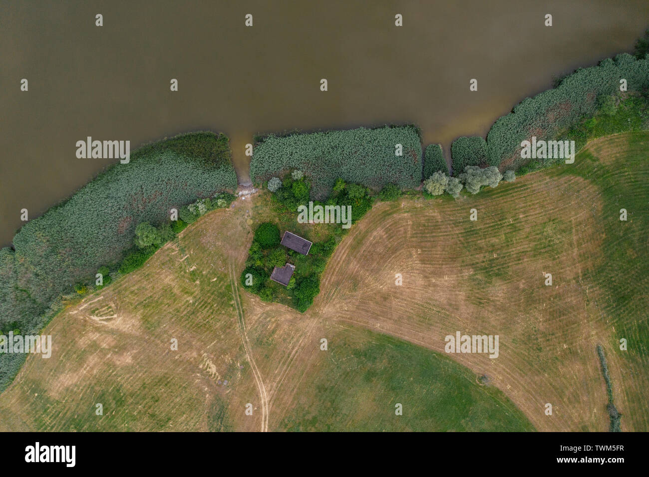 Top down view of a rural buildings, road and agricultural field in ...
