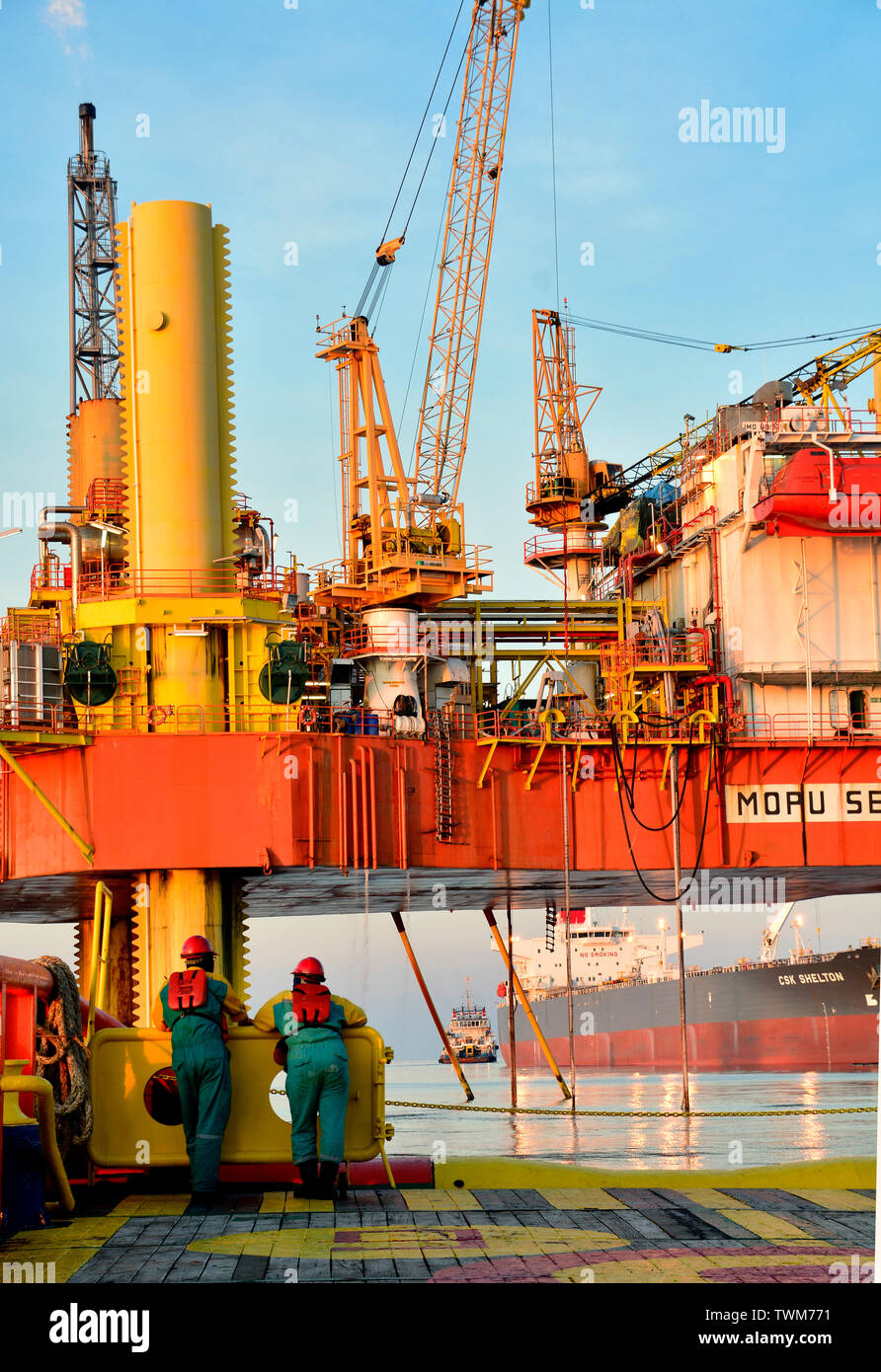 two marine crew stand by at aft vessel to received cargo from jack up ...