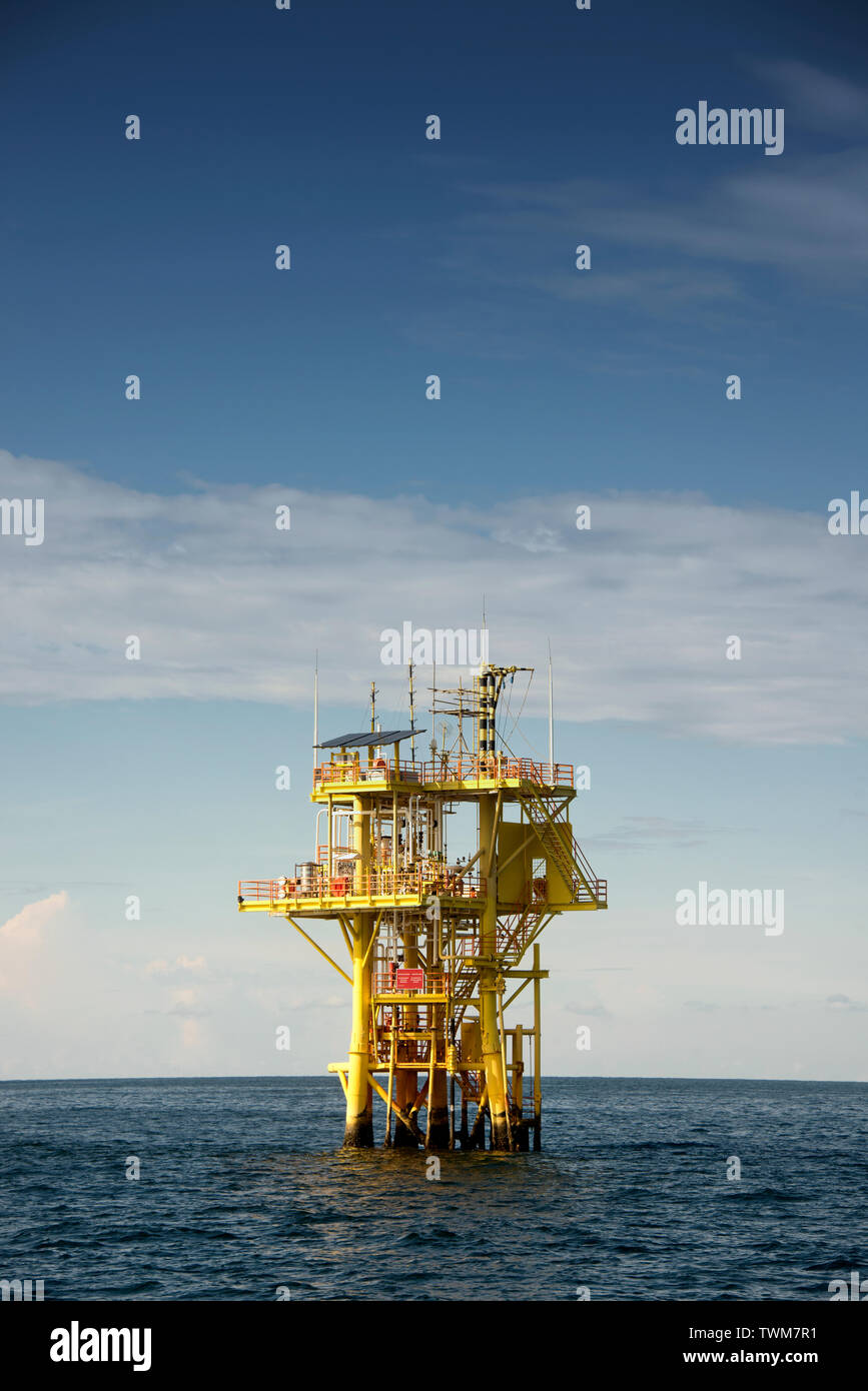 offshore oil platform at middle in the ocean with beautiful blue sky ...