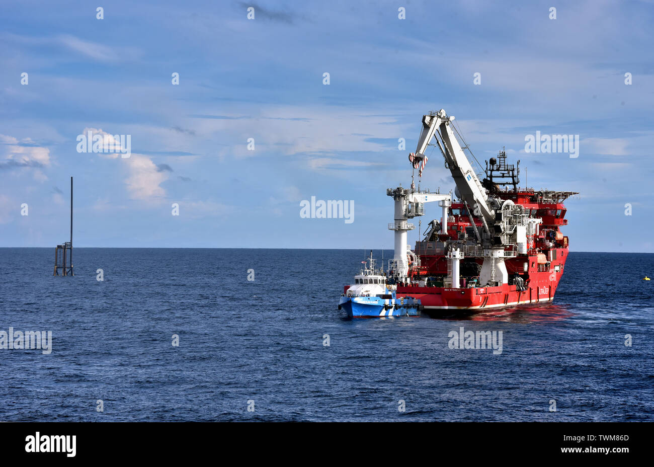 offshore vessel transfering cargo to fast crew boat to send it back to ...