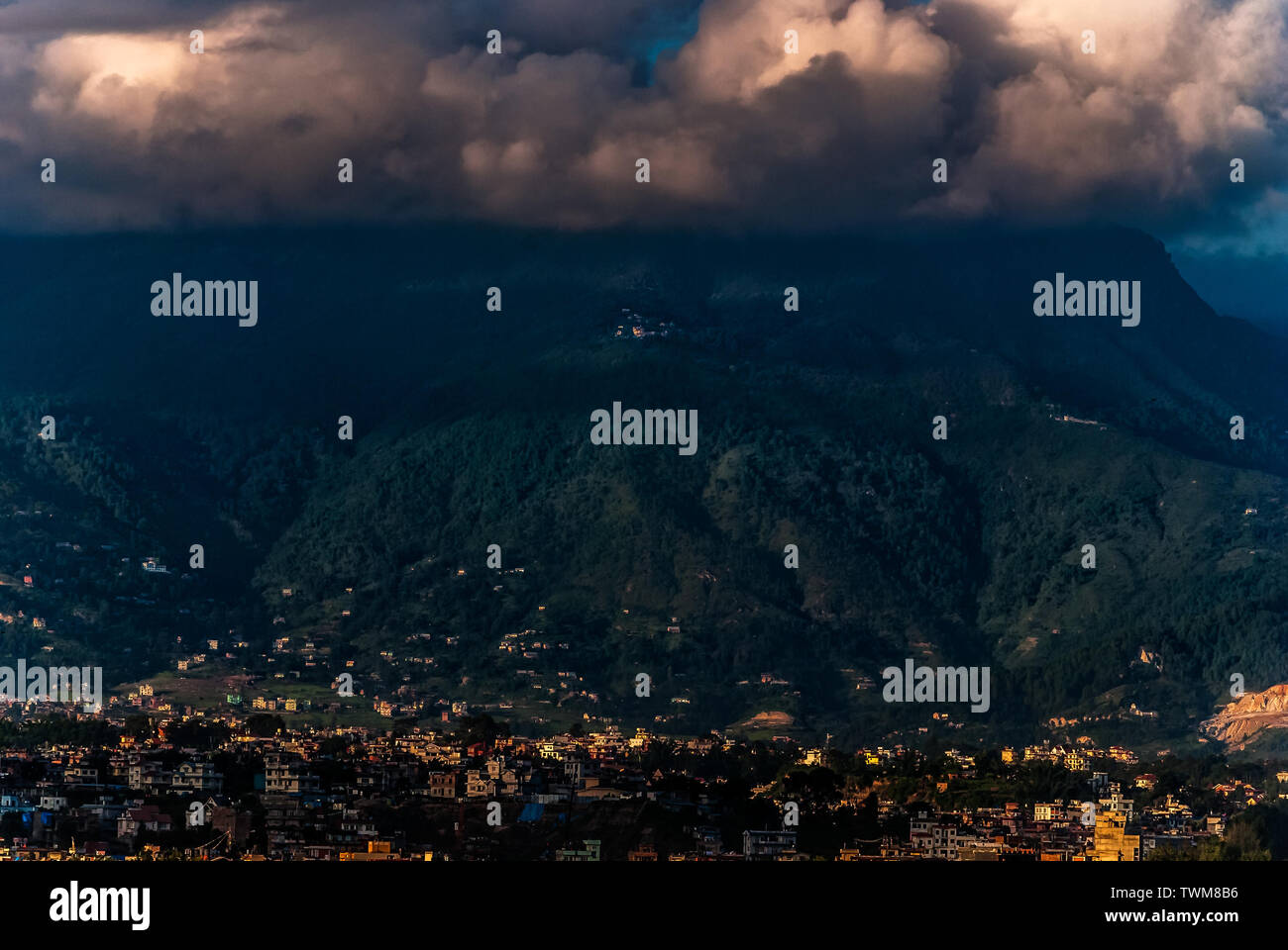 An aerial view of Kathmandu City in golden hour with stormy clouds at ...