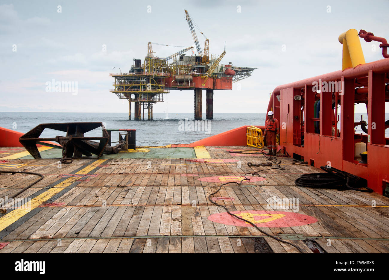 marine crew preparing anchor on deck before deploy the anchor to sea ...