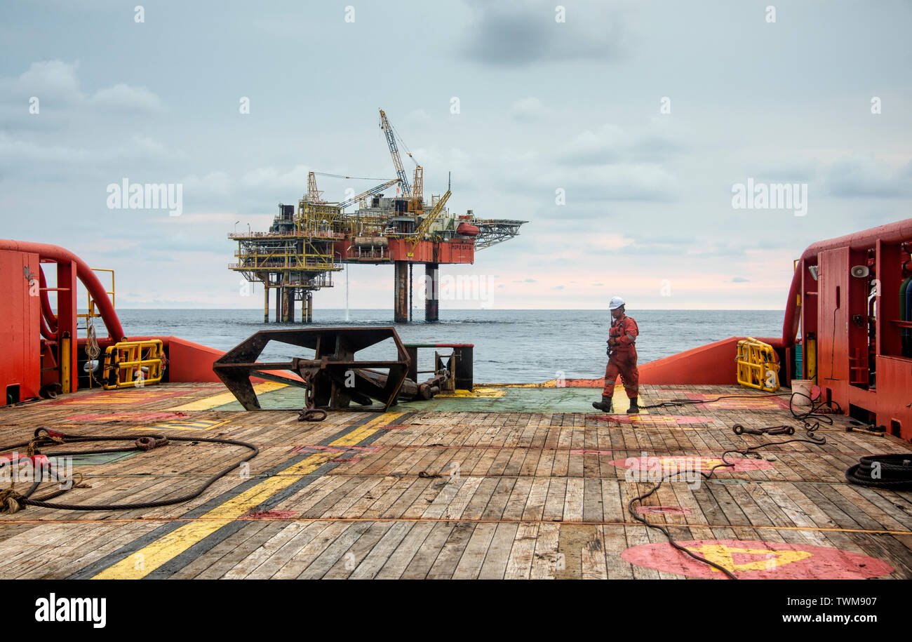 marine crew preparing anchor on deck before deploy the anchor to sea ...