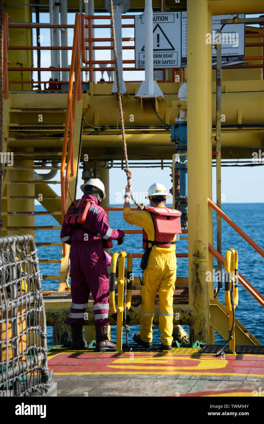 marine crew preparing oil platform personal to get ready for transfer ...
