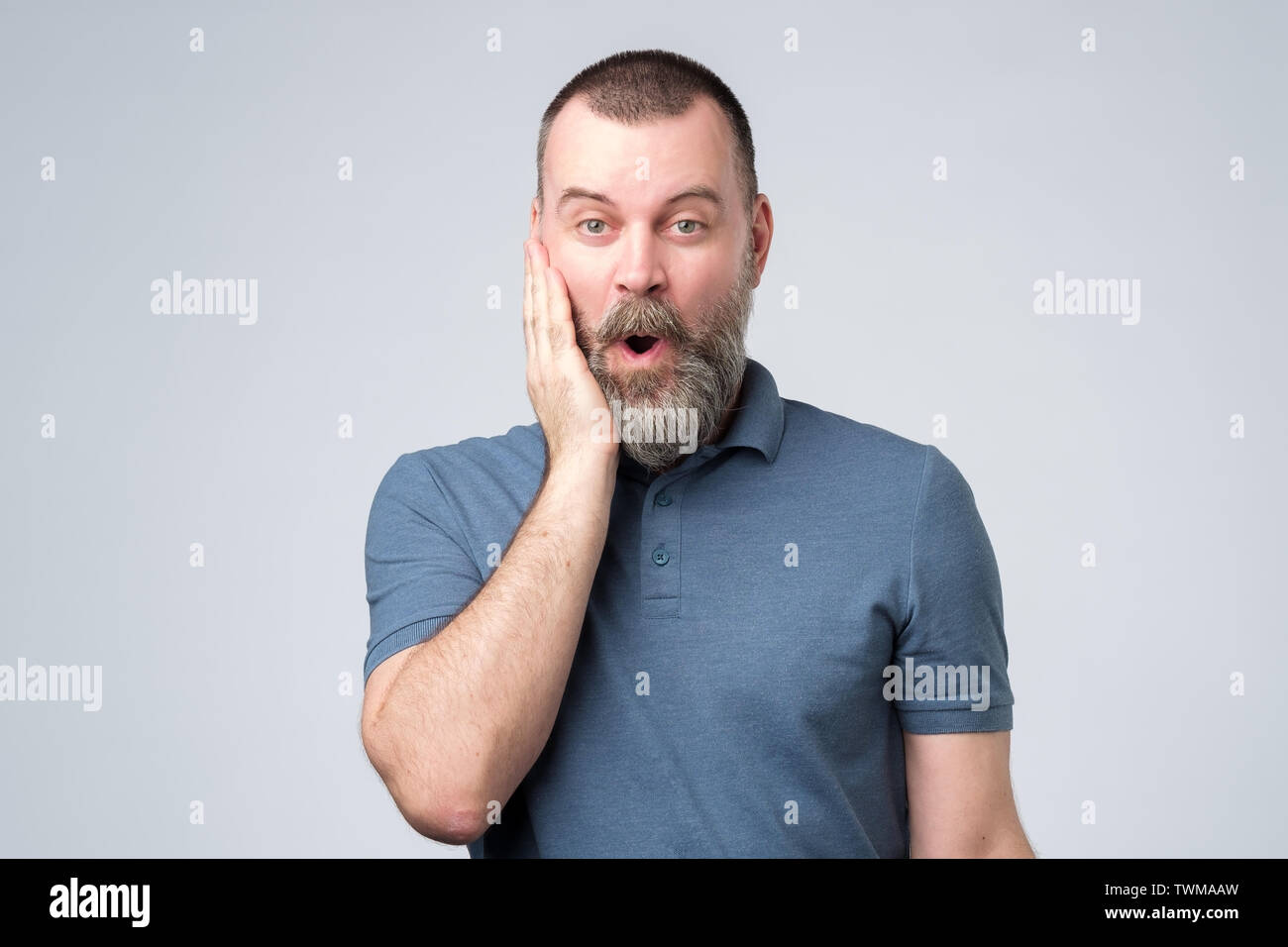 Surprised bearded man standing with open mouth Stock Photo - Alamy