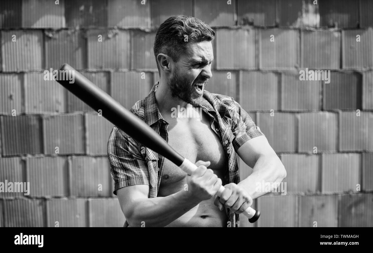 Attack concept. Bully guy carry cudgel brick wall background. Power and ...