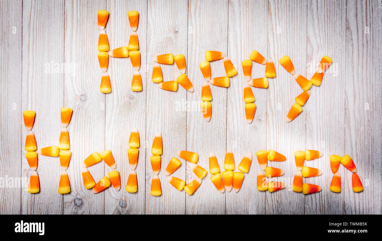 Candycorn candies spells Happy Halloween Stock Photo - Alamy