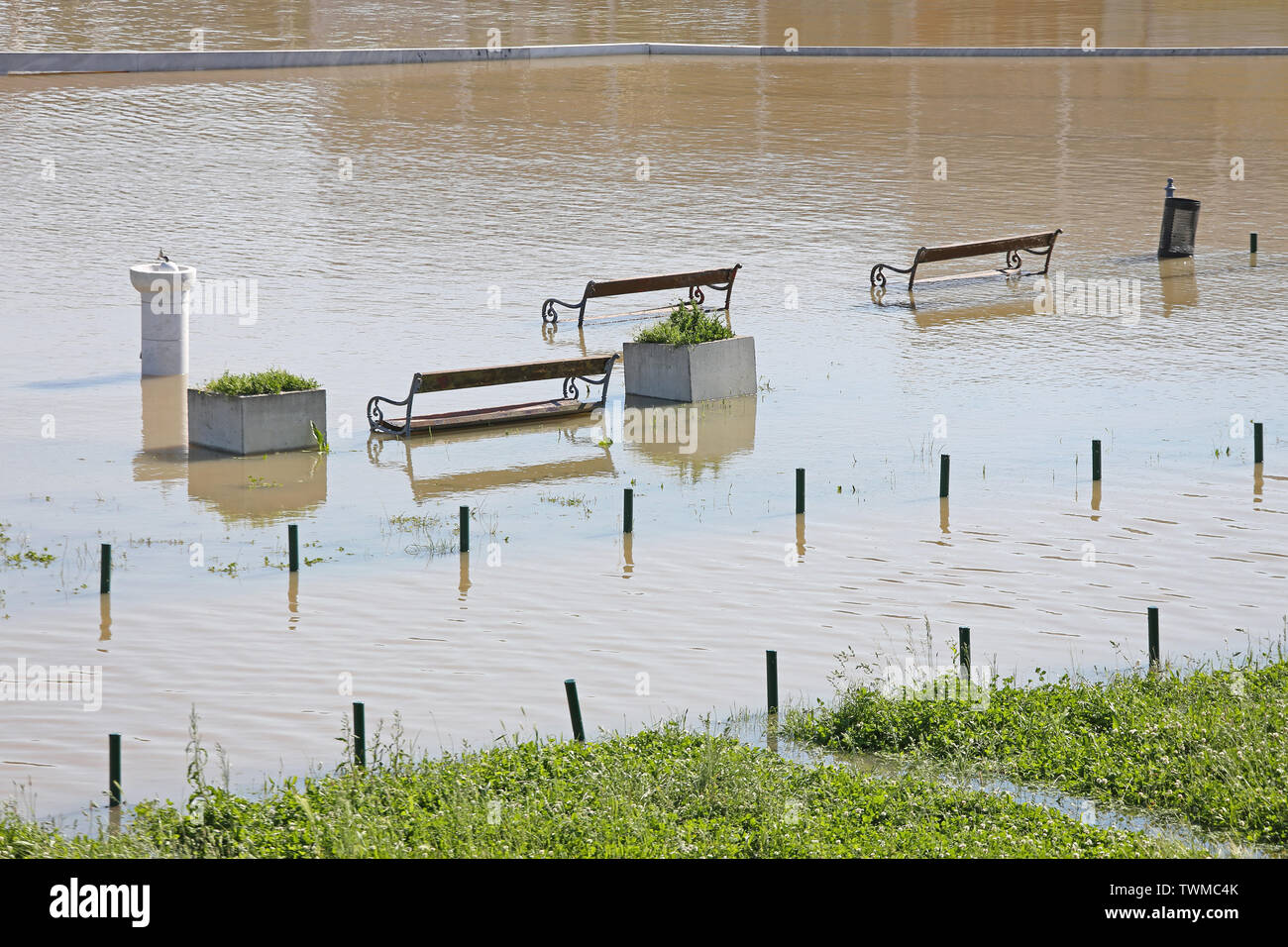 Benches Under Water in Flooded Park Natural Disaster Stock Photo - Alamy