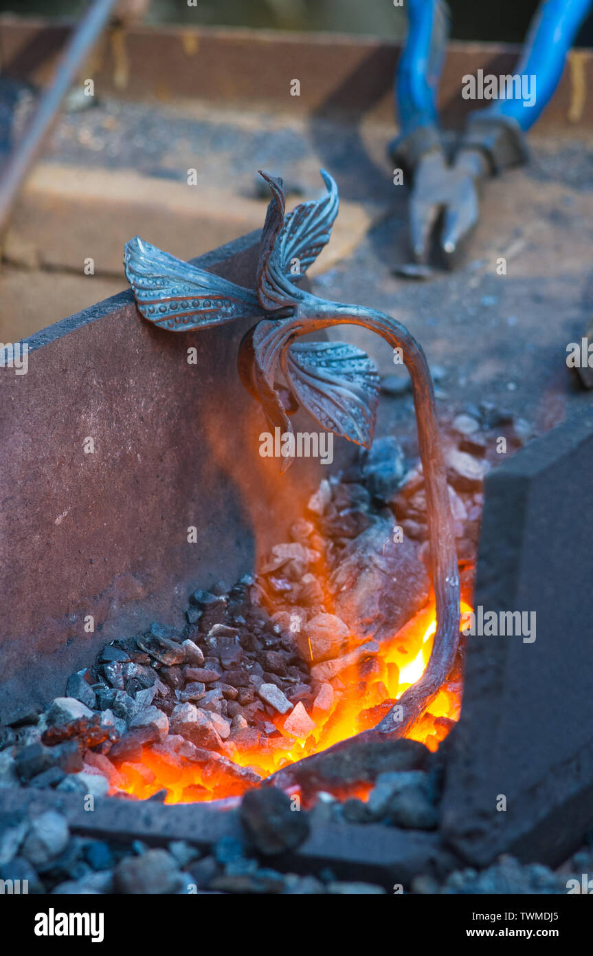 blacksmith furnace with burning coals, tools, and glowing hot metal ...