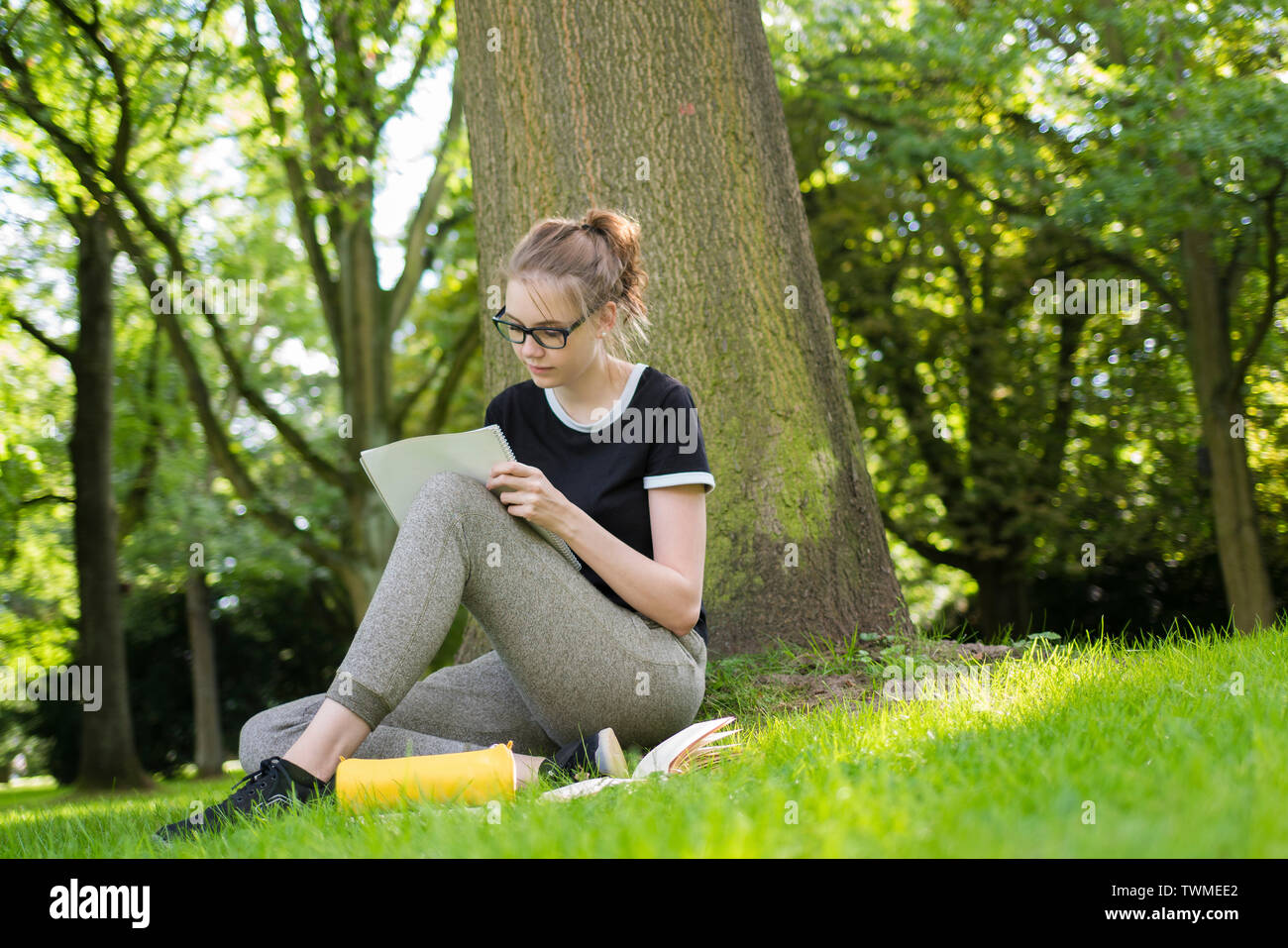 Female sitting under a tree hi-res stock photography and images - Alamy
