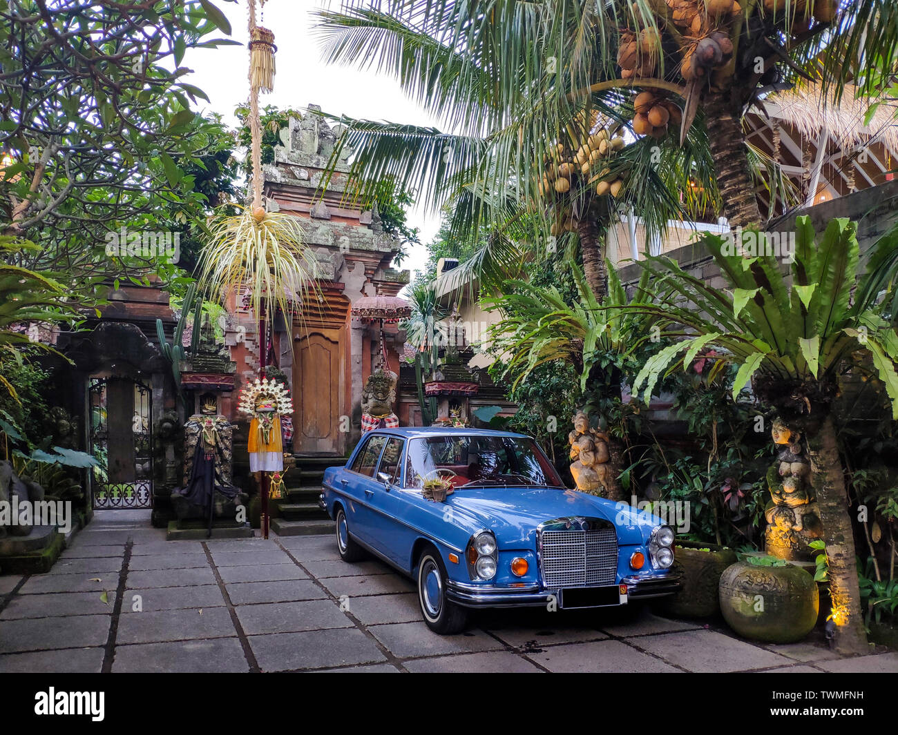 Blue retro car in front of a balinese traditional facade in Ubud, Bali ...