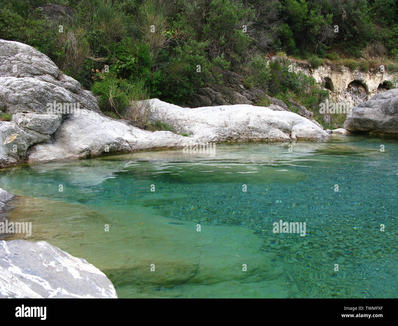 Blue river pool with ancient aqueduct behind Stock Photo - Alamy