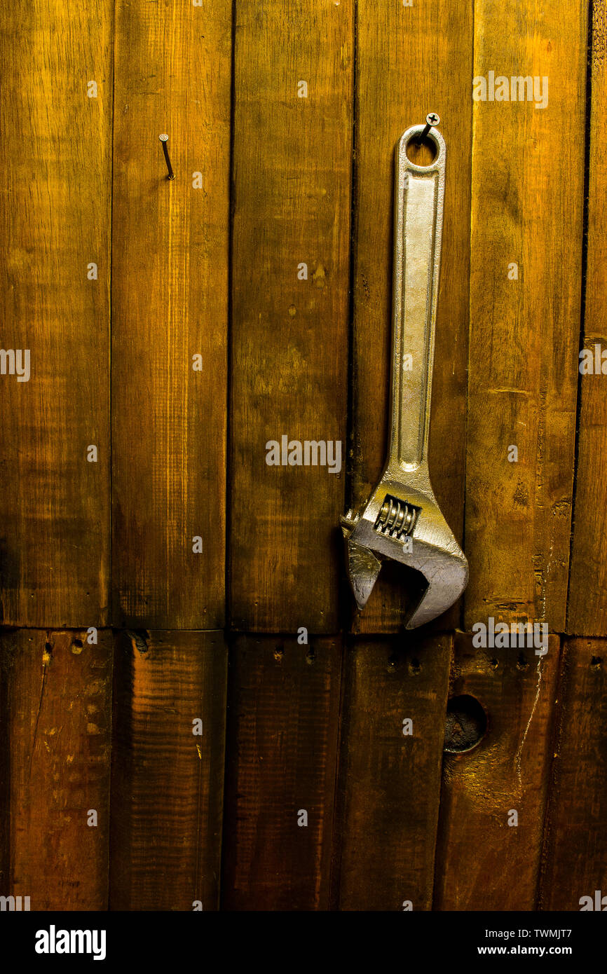 wrench hanging on wooden wall High resolution image gallery Stock Photo ...