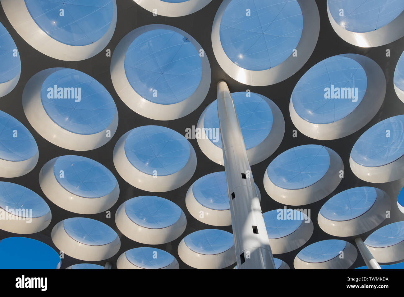 Modern roof with circle glass windows over passage shopping center ...