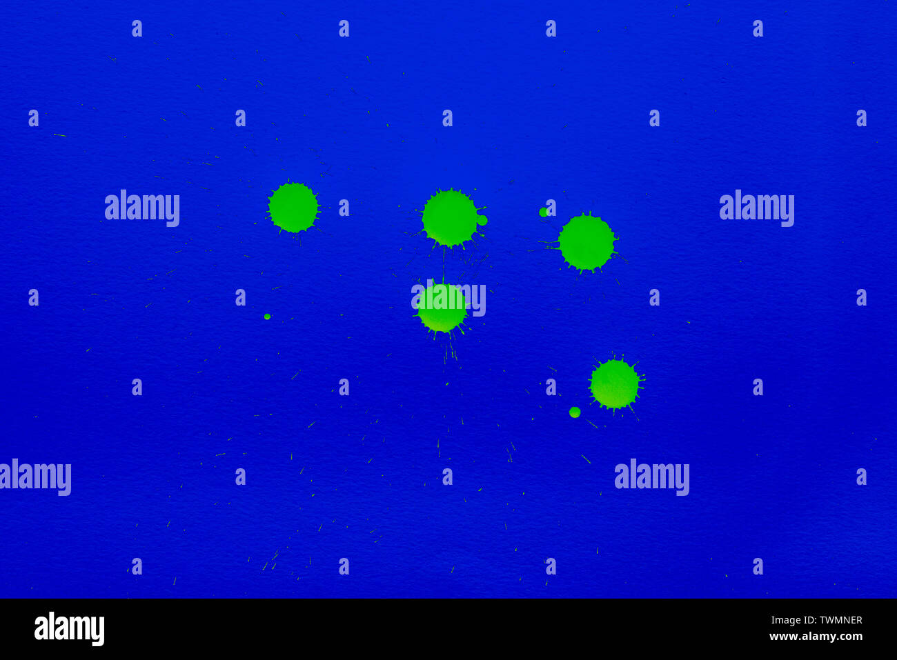 Paint splatter, on blue canvas. Bright green neon paint splash isolated ...