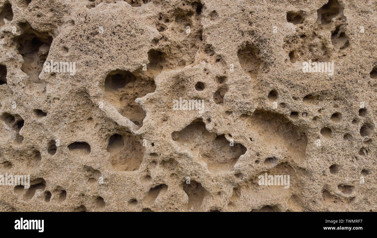 The surface of low density Sandstone is covered with potholes Stock ...