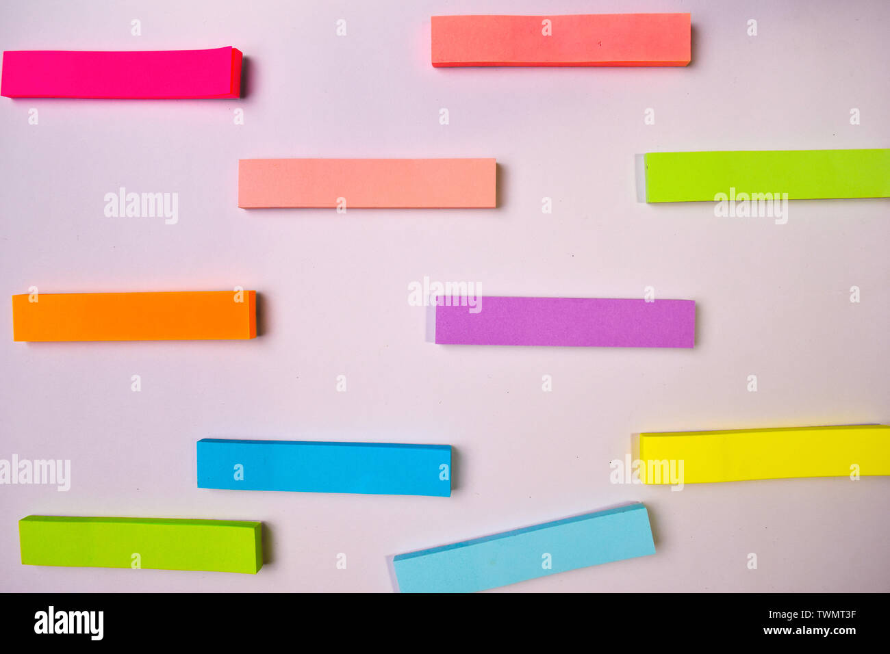 Collection of different colored sheets of note papers isolated on white ...