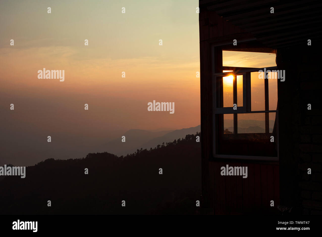 Window of house overlooking scenic views during sunset. Sun and ...