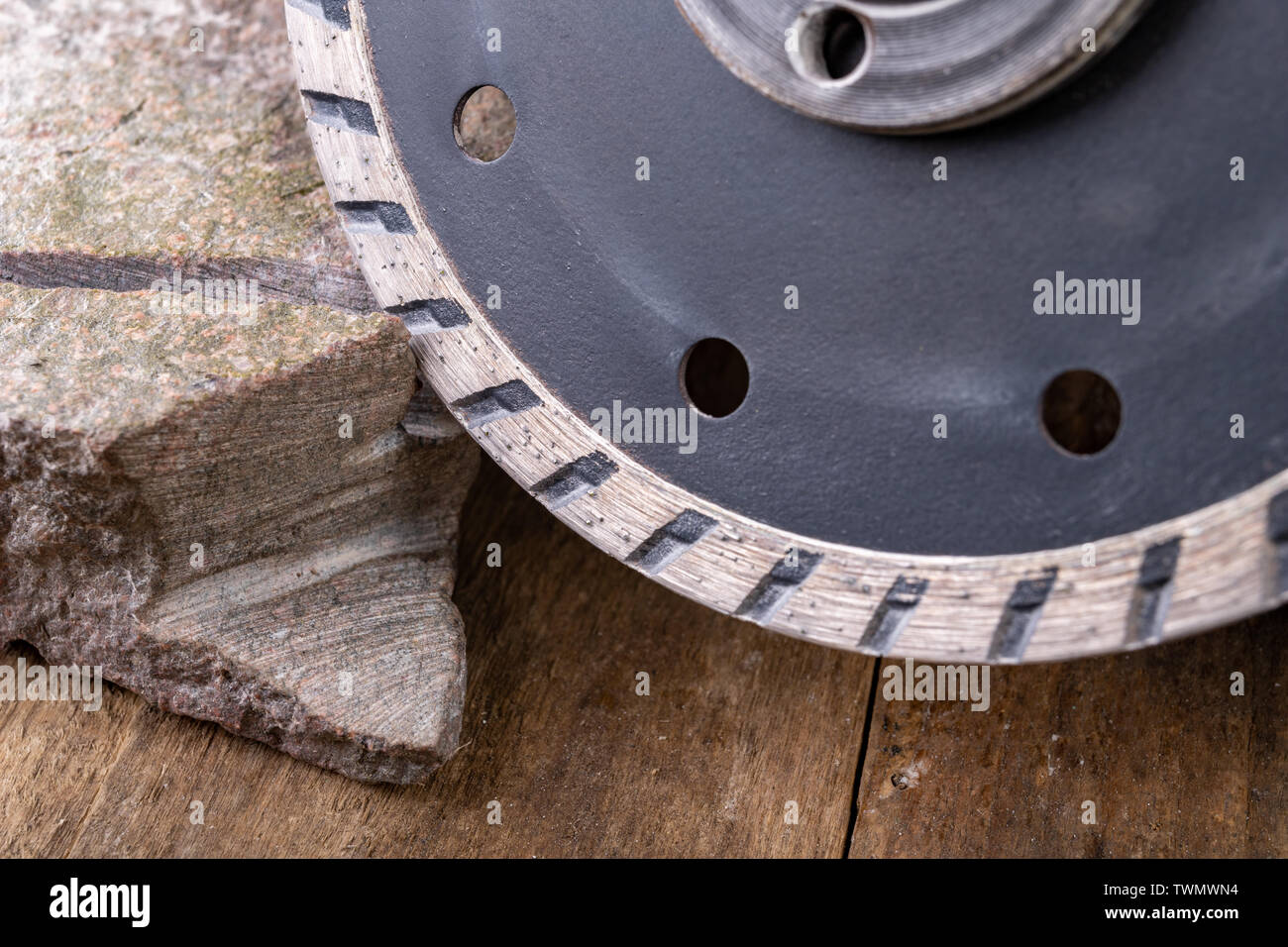 Stone cutting with a diamond disc mounted in a grinder. Work in a stone ...