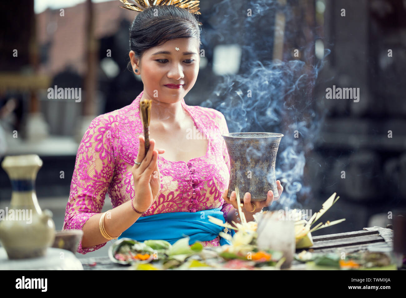 traditional scene of Balinese women praying with offering for Gods at ...