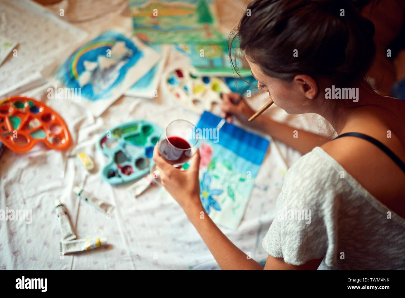 Young woman enjoy in painting with glass of vine Stock Photo - Alamy
