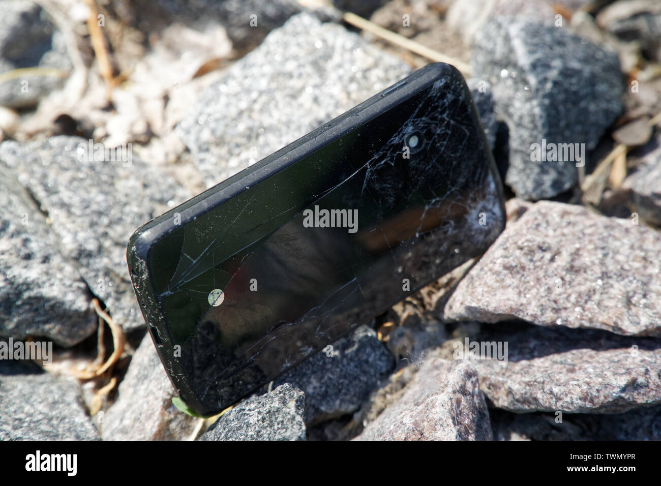 Broken cellphone abandoned and lost among the gravel Stock Photo - Alamy