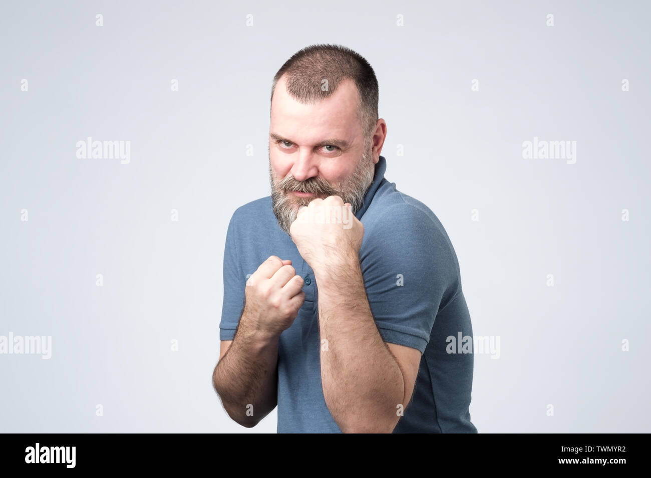 man in blue shirt standing in boxer pose with raised fist Stock Photo ... man in blue shirt standing in boxer pose with raised fist Stock Photo ...
