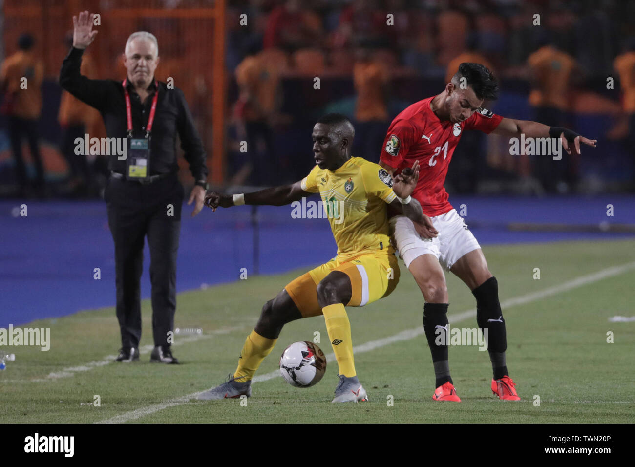 Cairo, Egypt. 21st June, 2019. Egypt's Nabil Emad (R) and Zimbabwe's ...