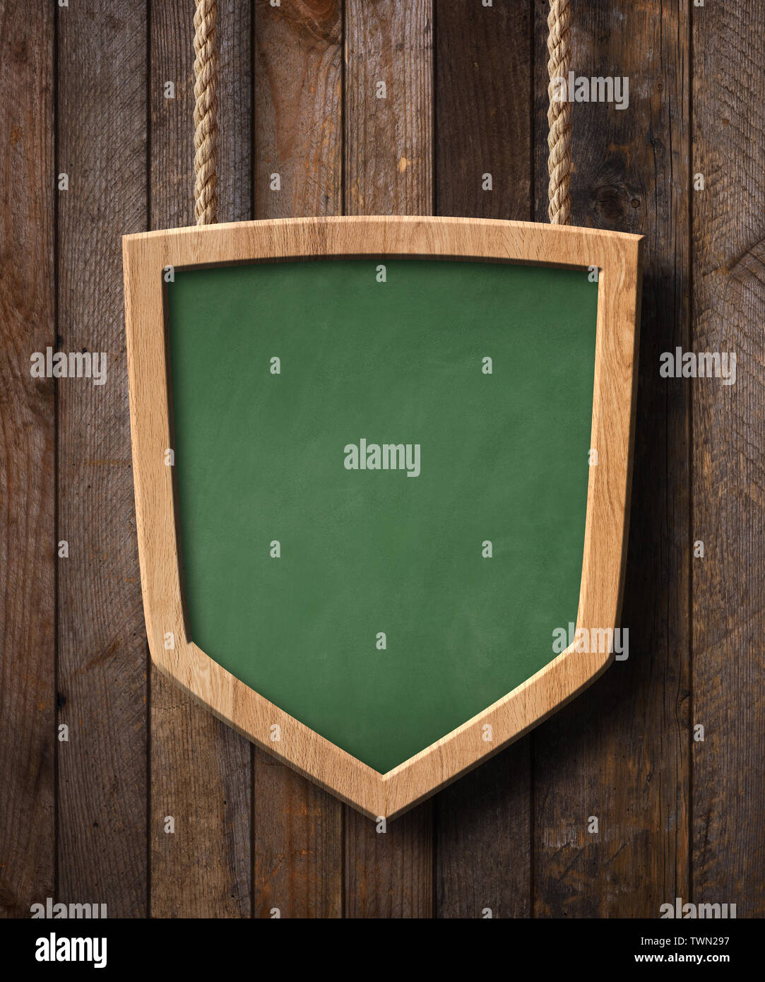 Protection shield shaped green blackboard hanging on ropes and wood ...