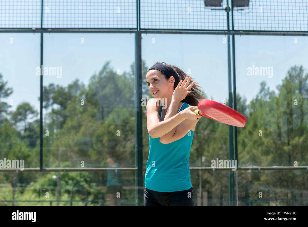 Young woman playing padel outdoor Stock Photo - Alamy
