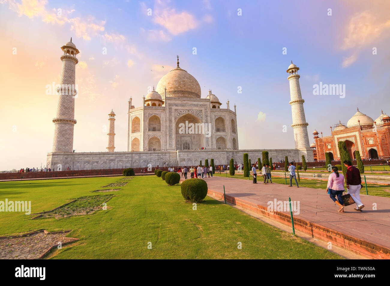 Taj Mahal historic marble mausoleum at sunset with view of tourists ...