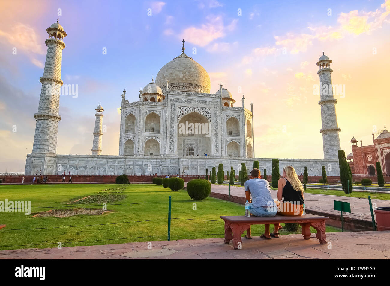 Taj Mahal sunrise view with tourist couple enjoying a romantic moment ...