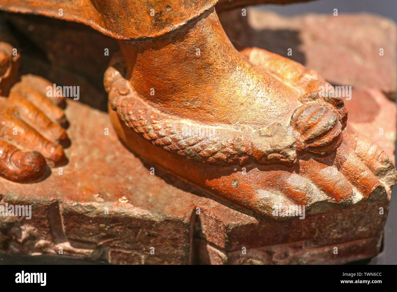 Ancient Indian sandstone sculpture of woman feet in close up macro view ...