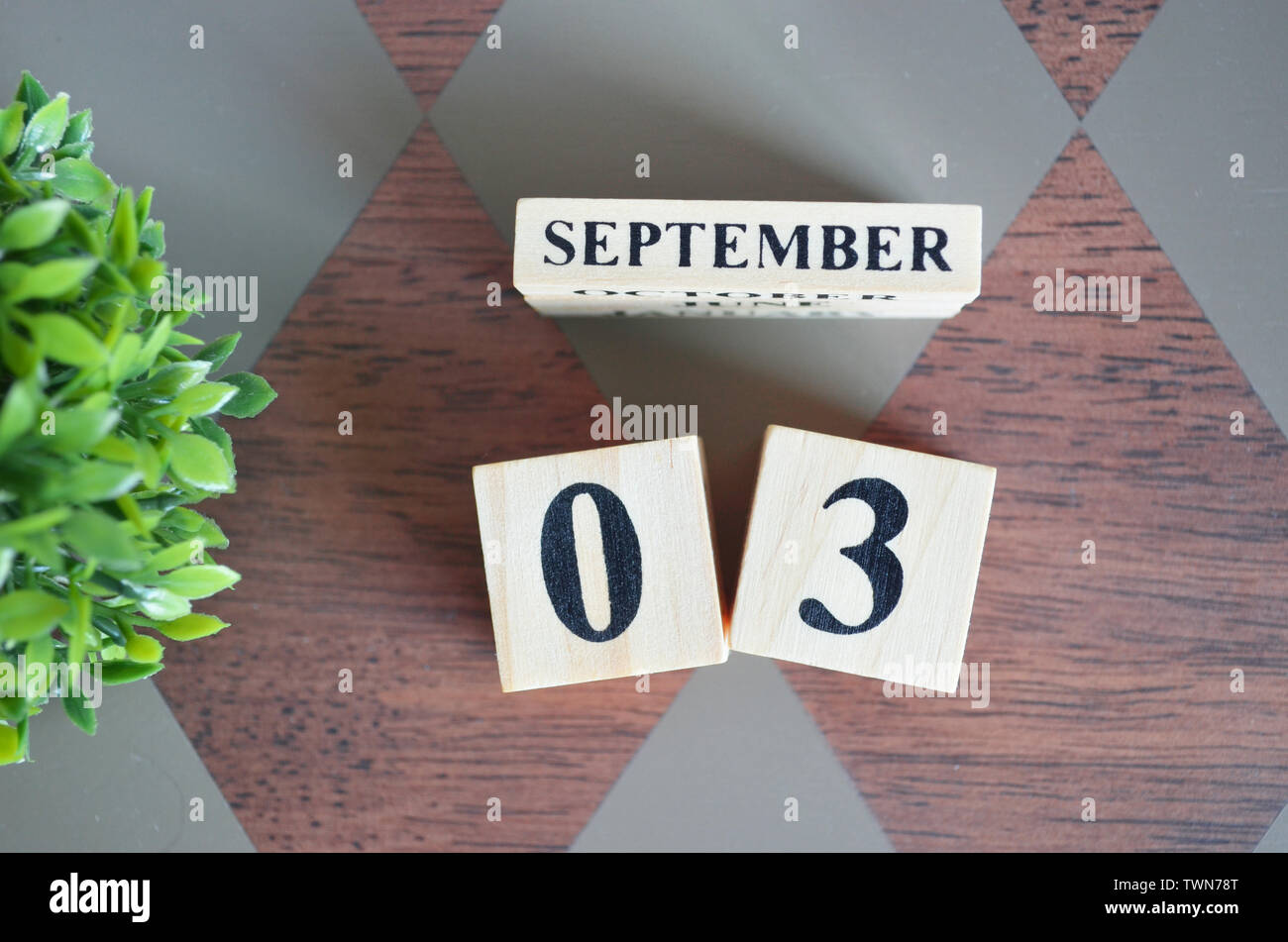 Date of September with leaf on diamond pattern table for background ...