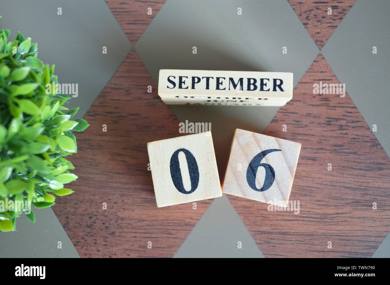 Date of September with leaf on diamond pattern table for background ...