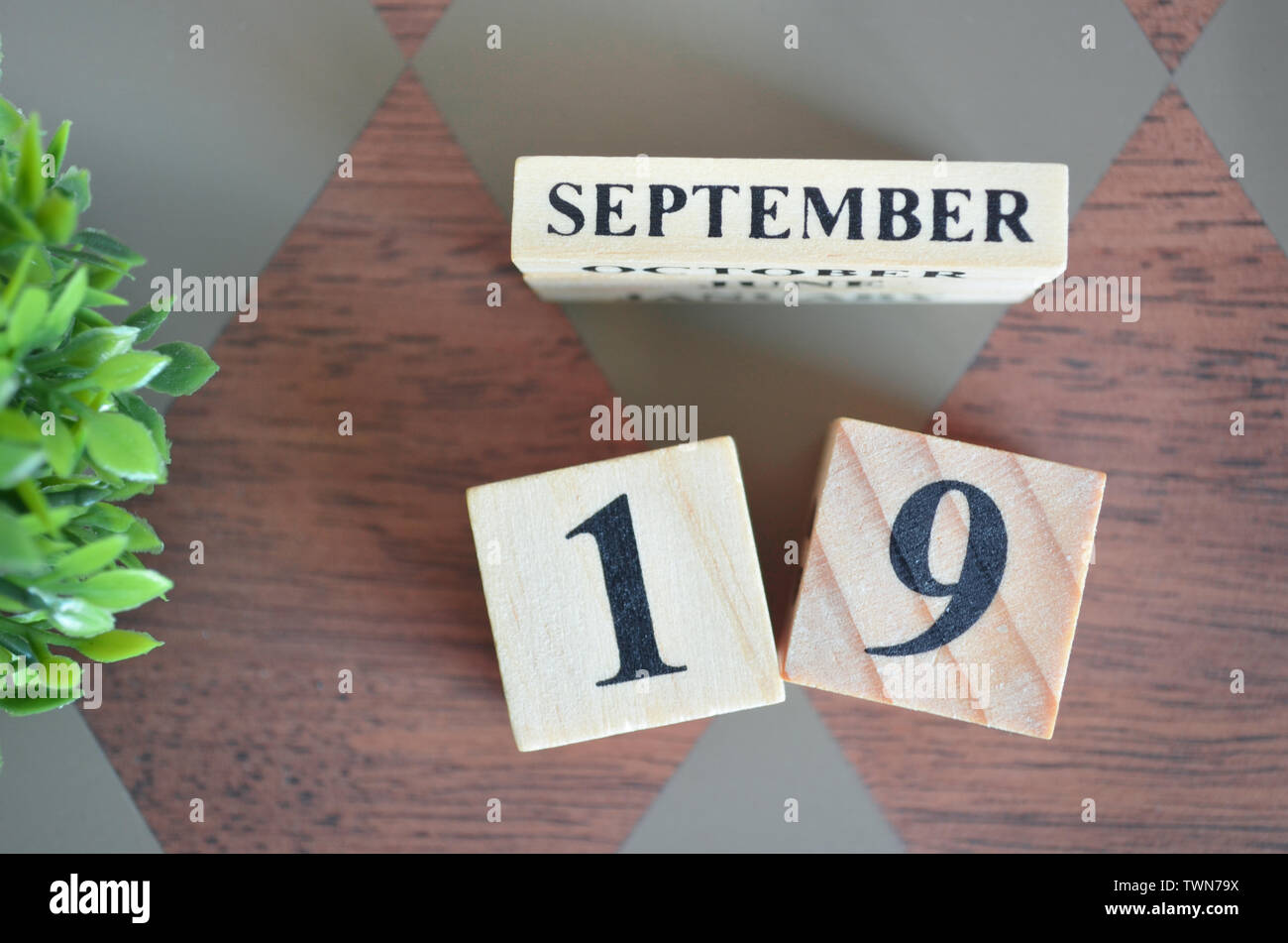 Date of September with leaf on diamond pattern table for background ...