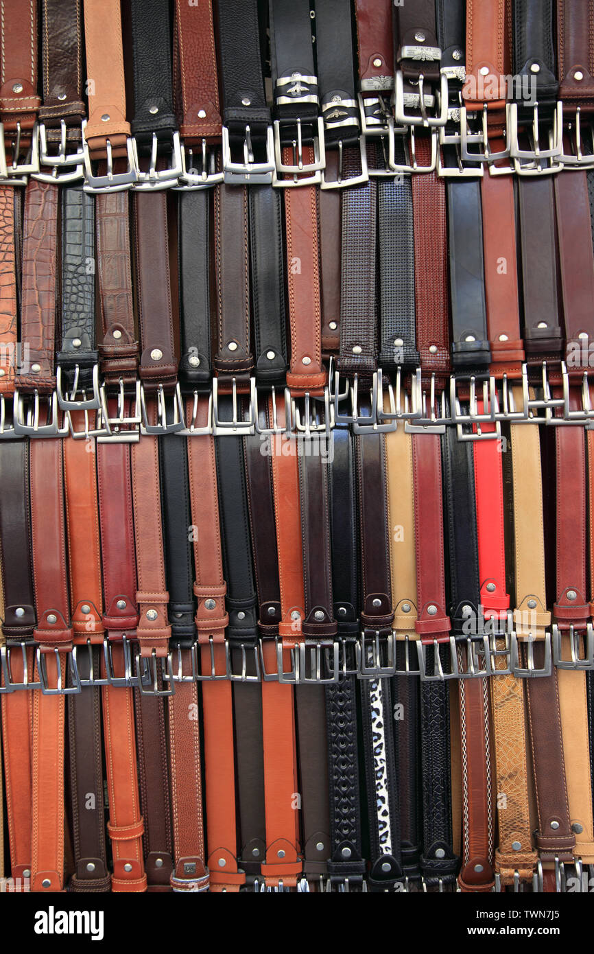 Belts on display in a leather market in Florence Italy Stock Photo - Alamy