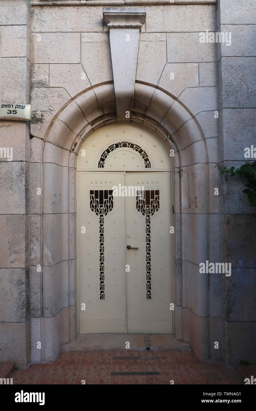 An arched doorway of an old house located in 35 Emek Refaim street in ...