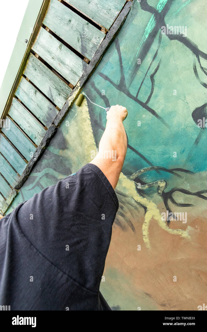 Artist Jim Vision. Creation of a large wall mural with a natural ...