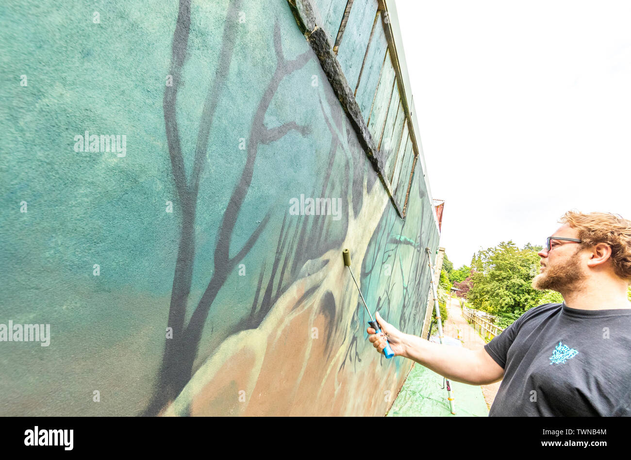 Artist Jim Vision. Creation of a large wall mural with a natural ...